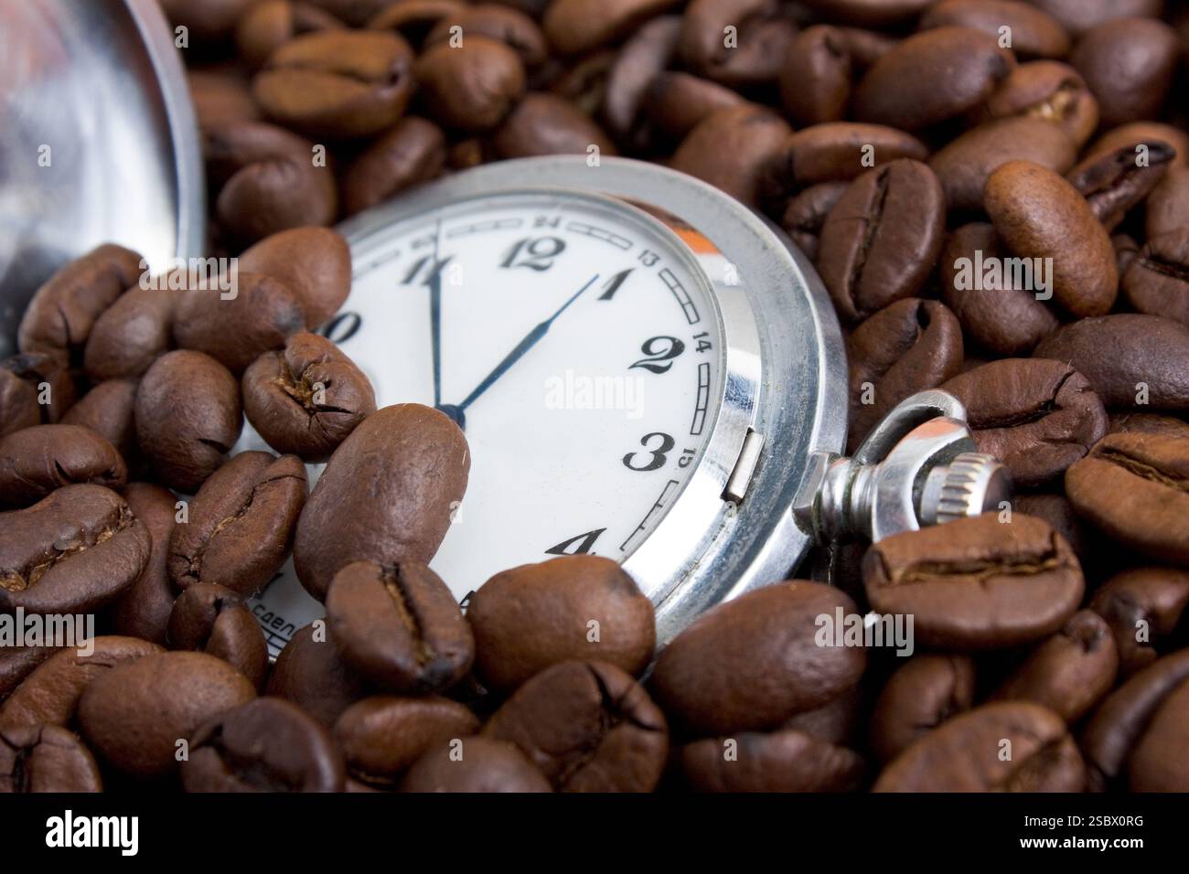 Pocket watch in coffee beans Stock Photo - Alamy