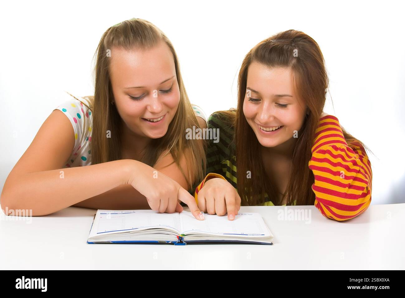 The girls read the book isolated on white background Stock Photo - Alamy