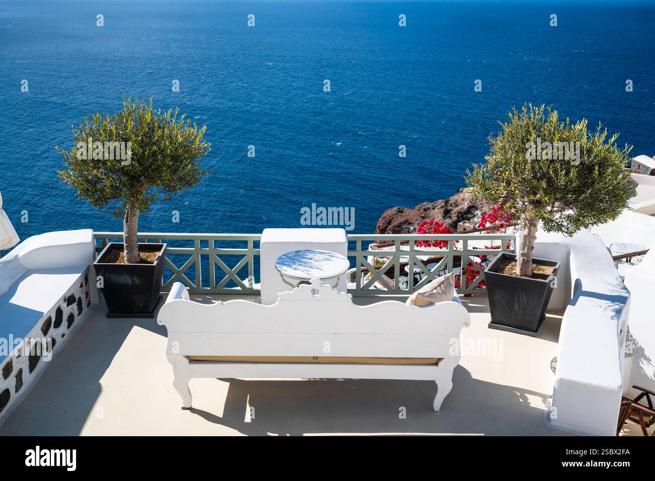 A white wooden bench with table on a panoramic terrace with two olive ...