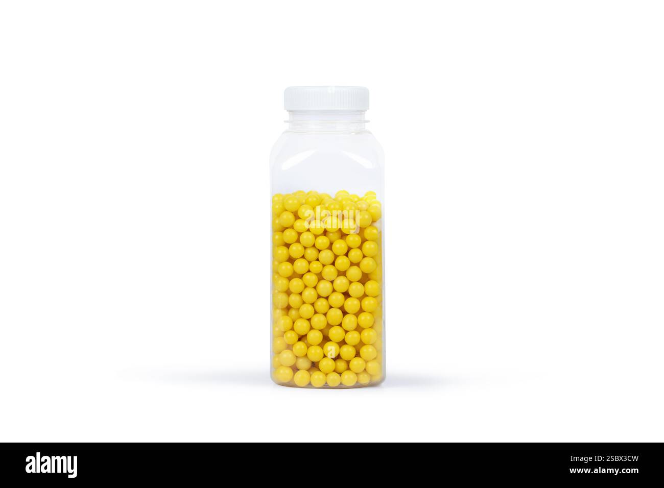 Transparent Plastic Bottle with Golden Spherical Pills on White ...
