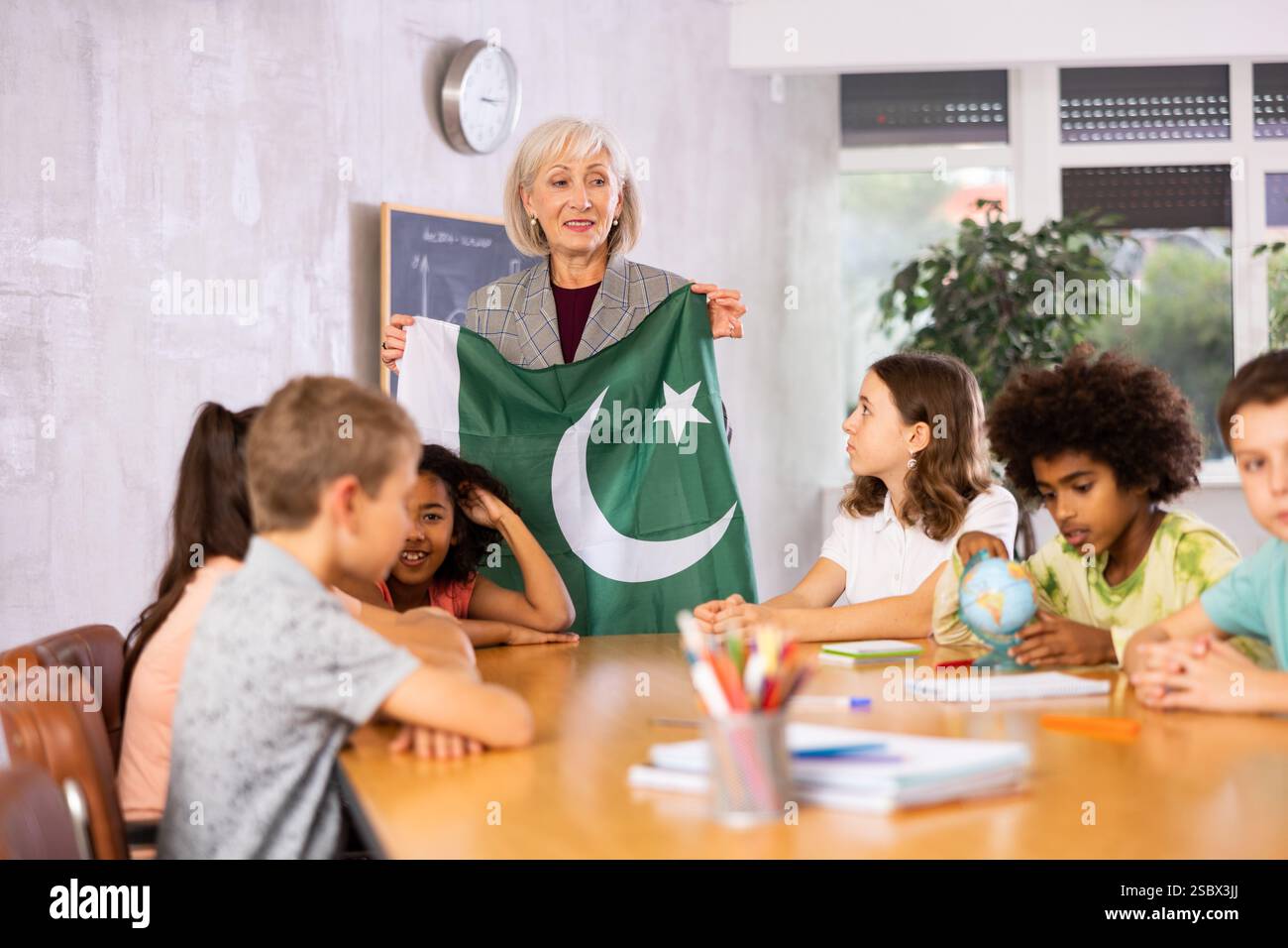 students listen to woman teacher who talks about Pakistan Stock Photo ...