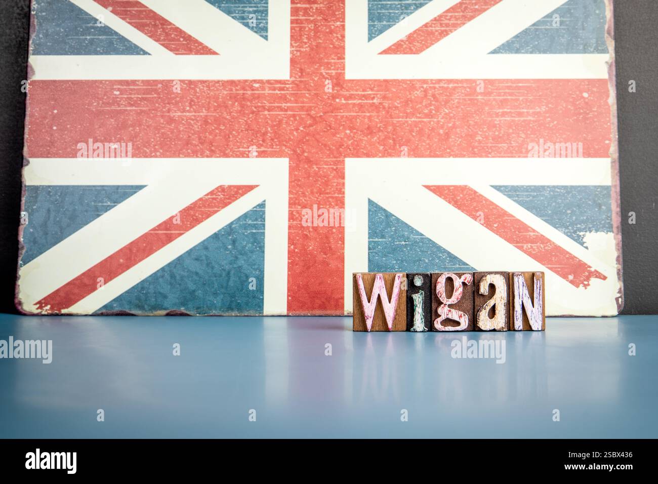 WIGAN. Urban Area in Great Britain. Flag and alphabet letters on wooden ...