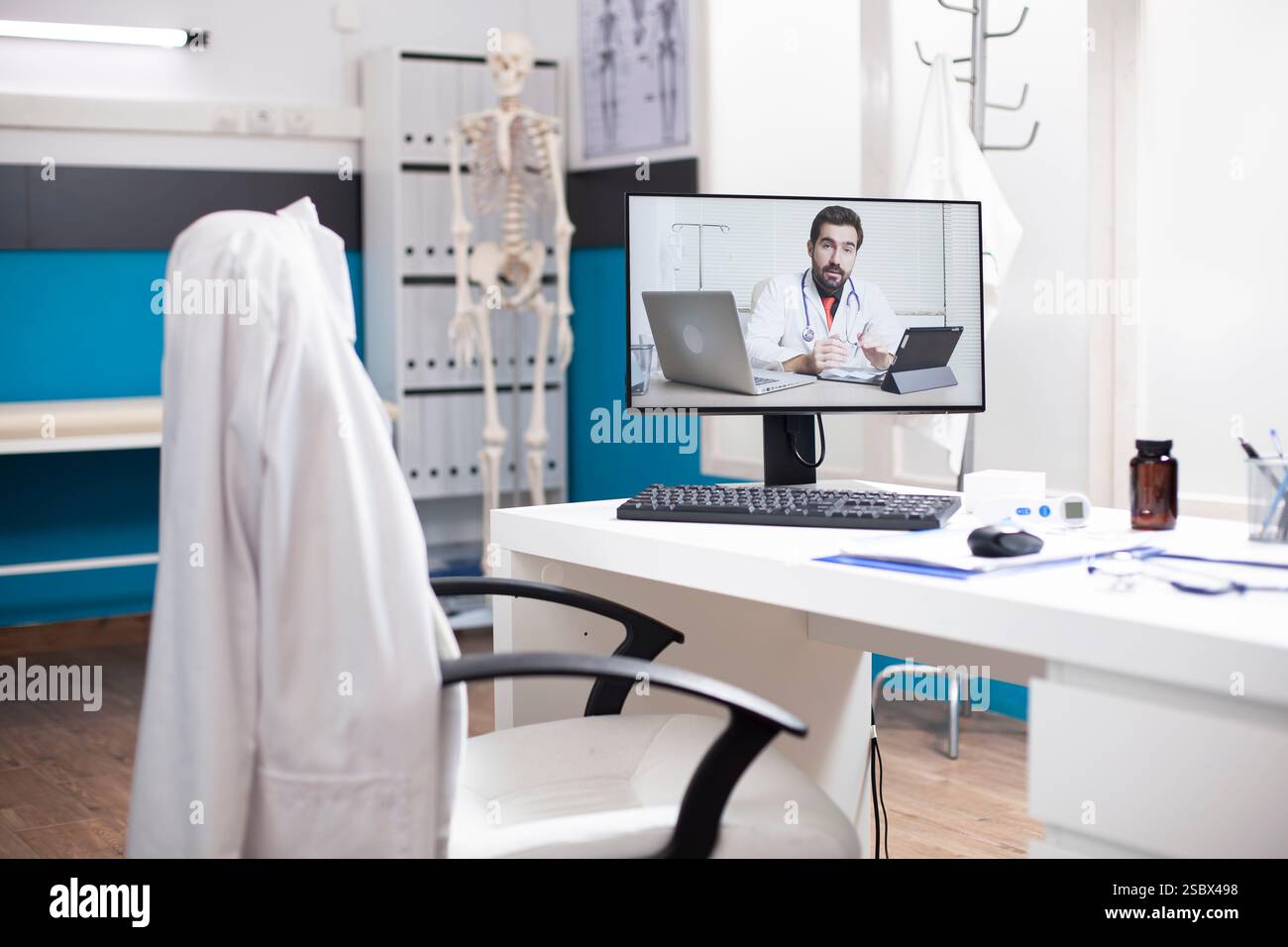 Caucasian doctor videocall displayed on desktop pc positioned on table ...