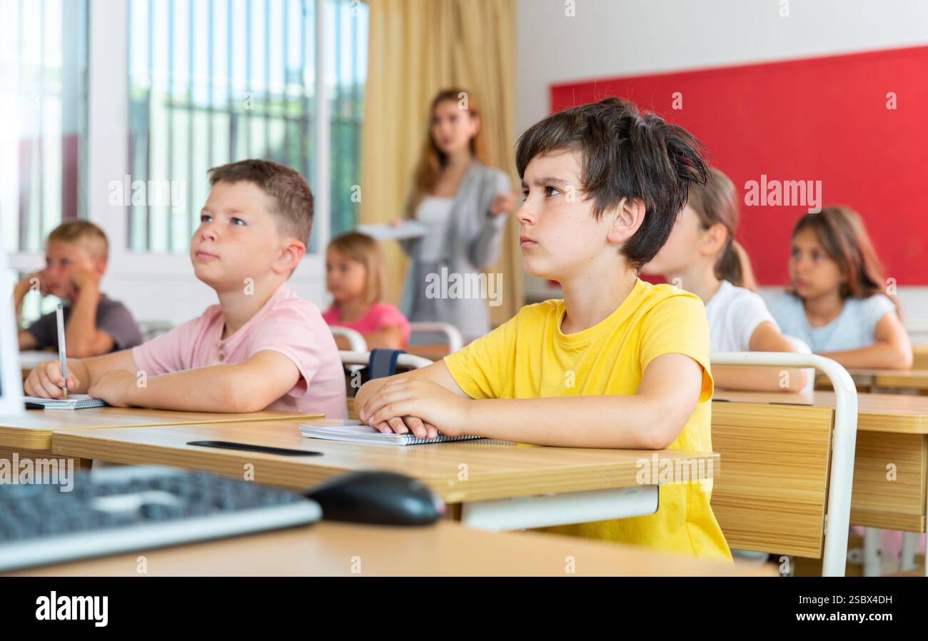 Kids studying in classroom Stock Photo - Alamy