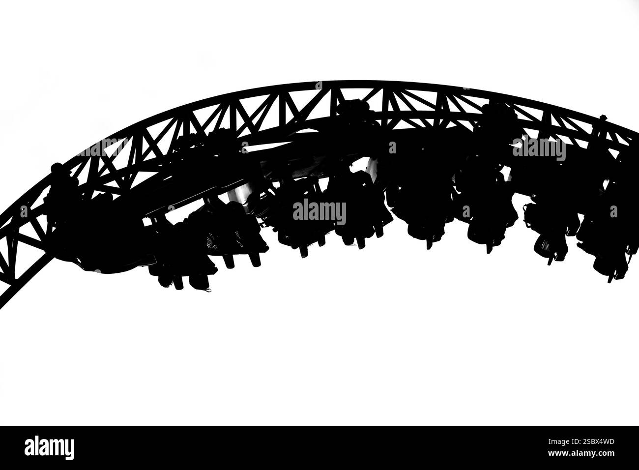 silhouette of roller coaster riders in mid-air loop Stock Photo - Alamy
