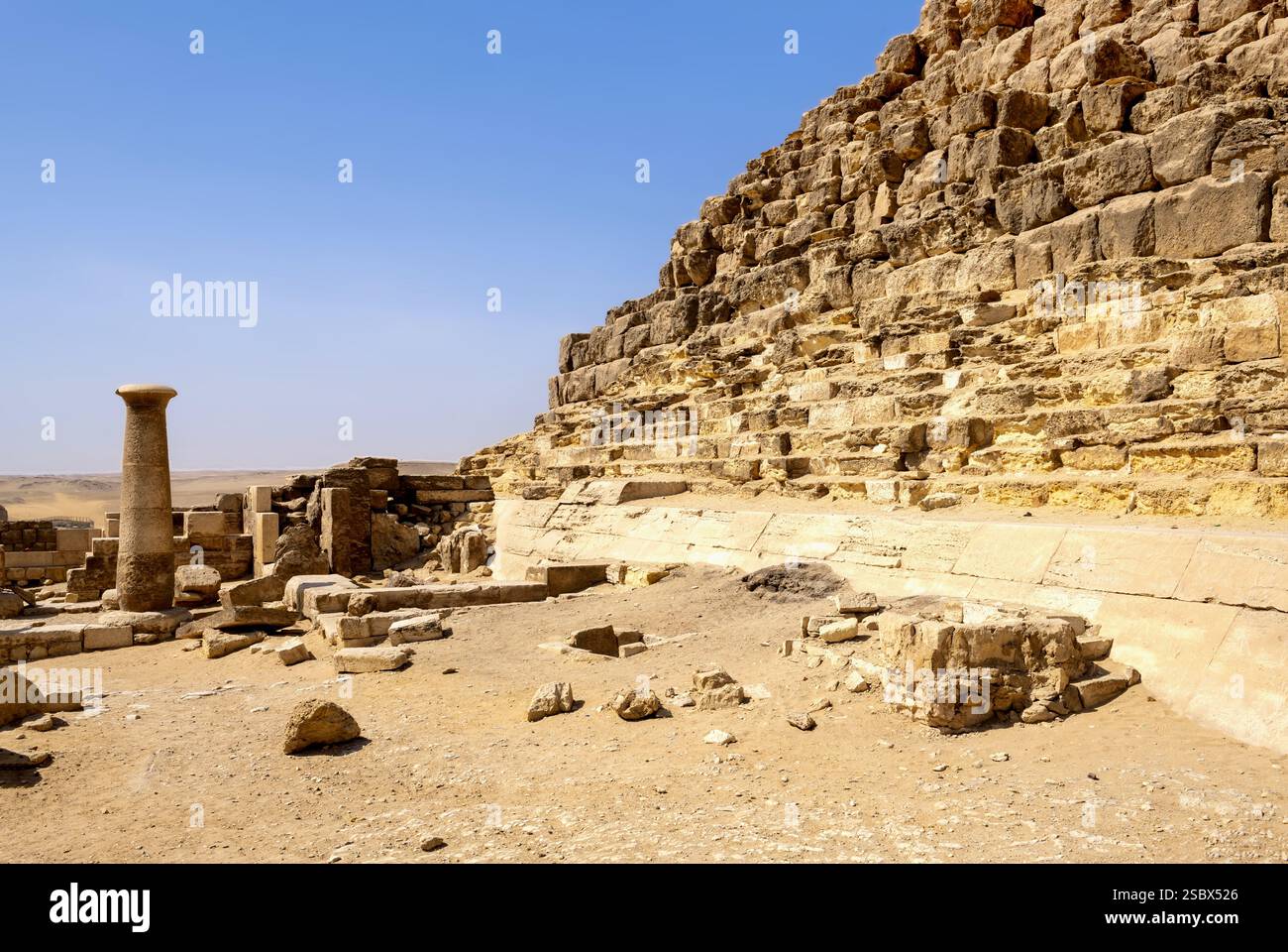 Column and the corner of the Pyramid of Queen Henutsen in Giza, Egypt ...