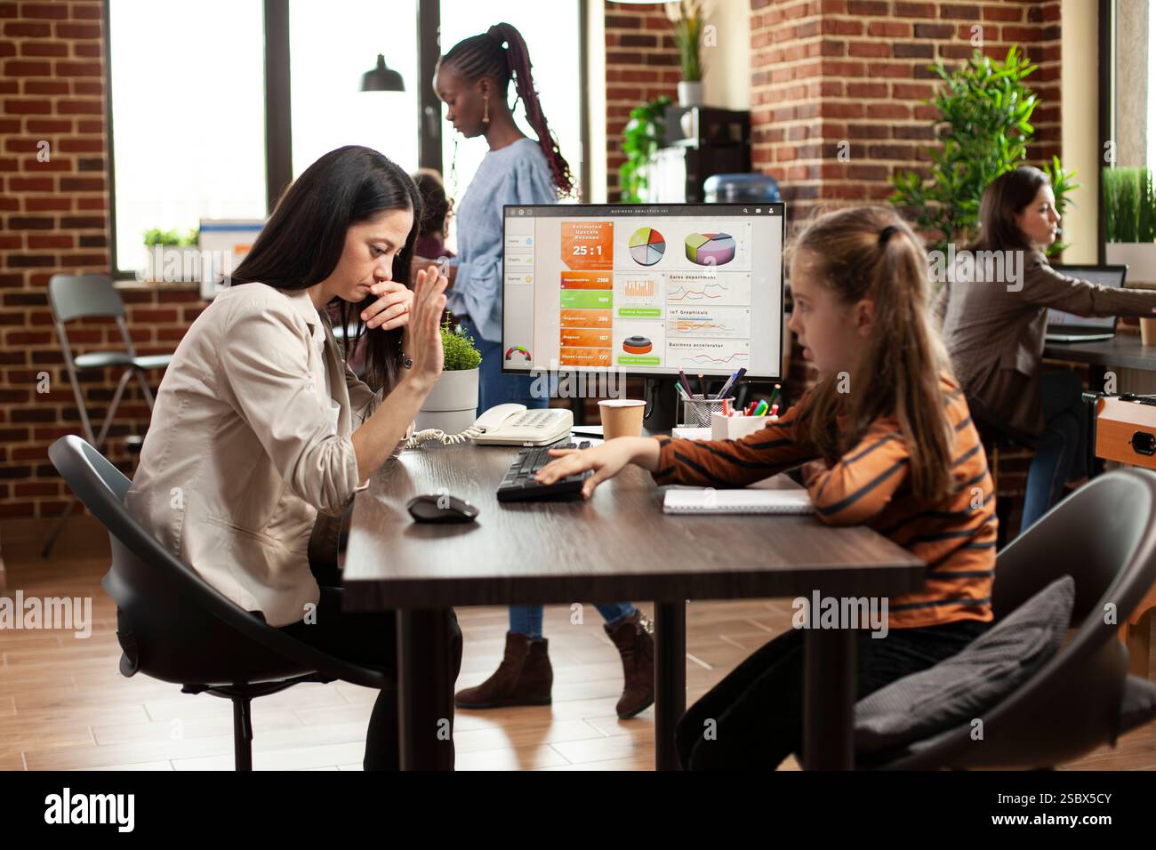 Working mom reviewing market strategy on desktop pc and annoyed by ...