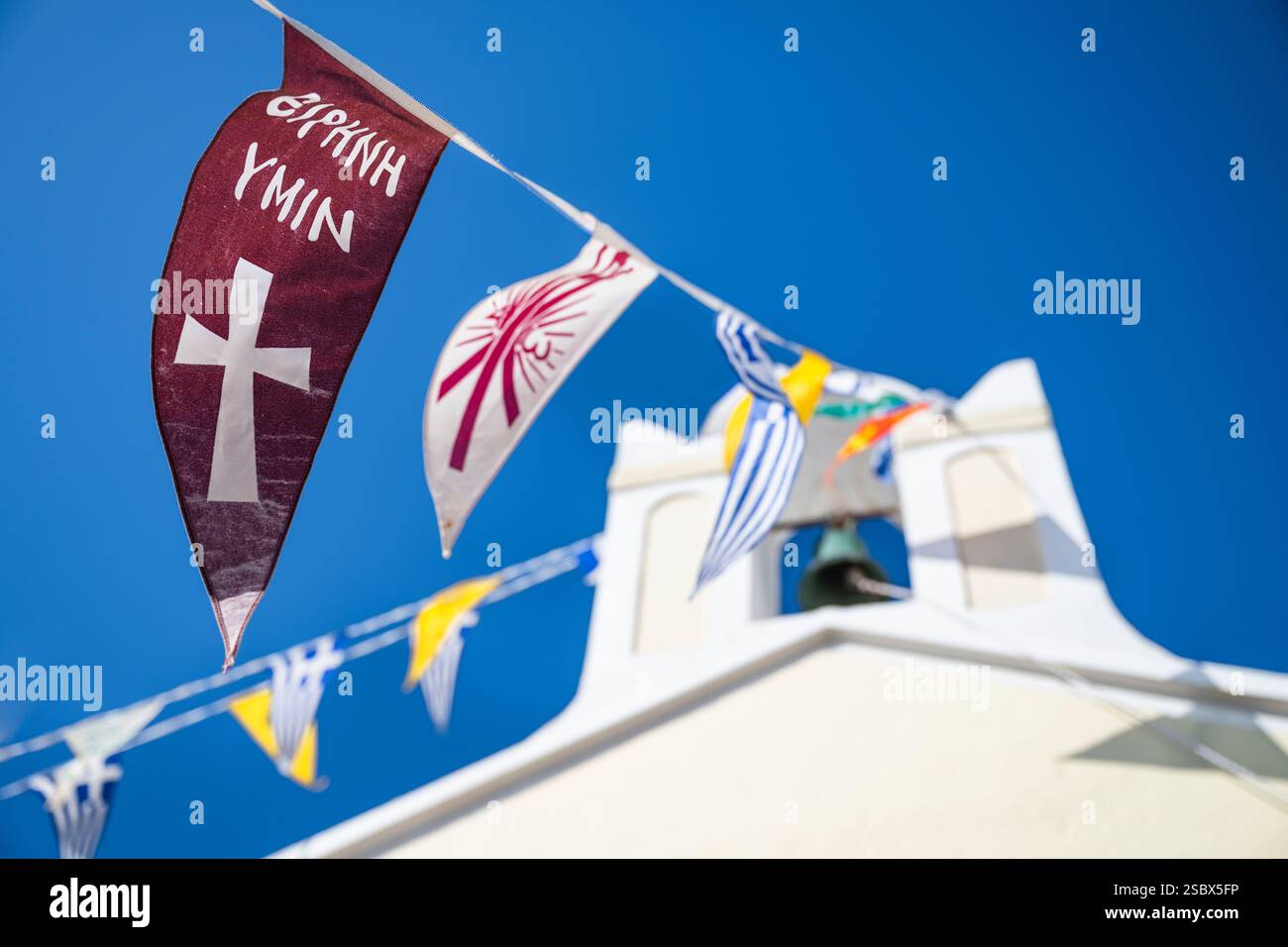 Colorful pennants decorate the Holy Church of Taxiarches on the feast ...