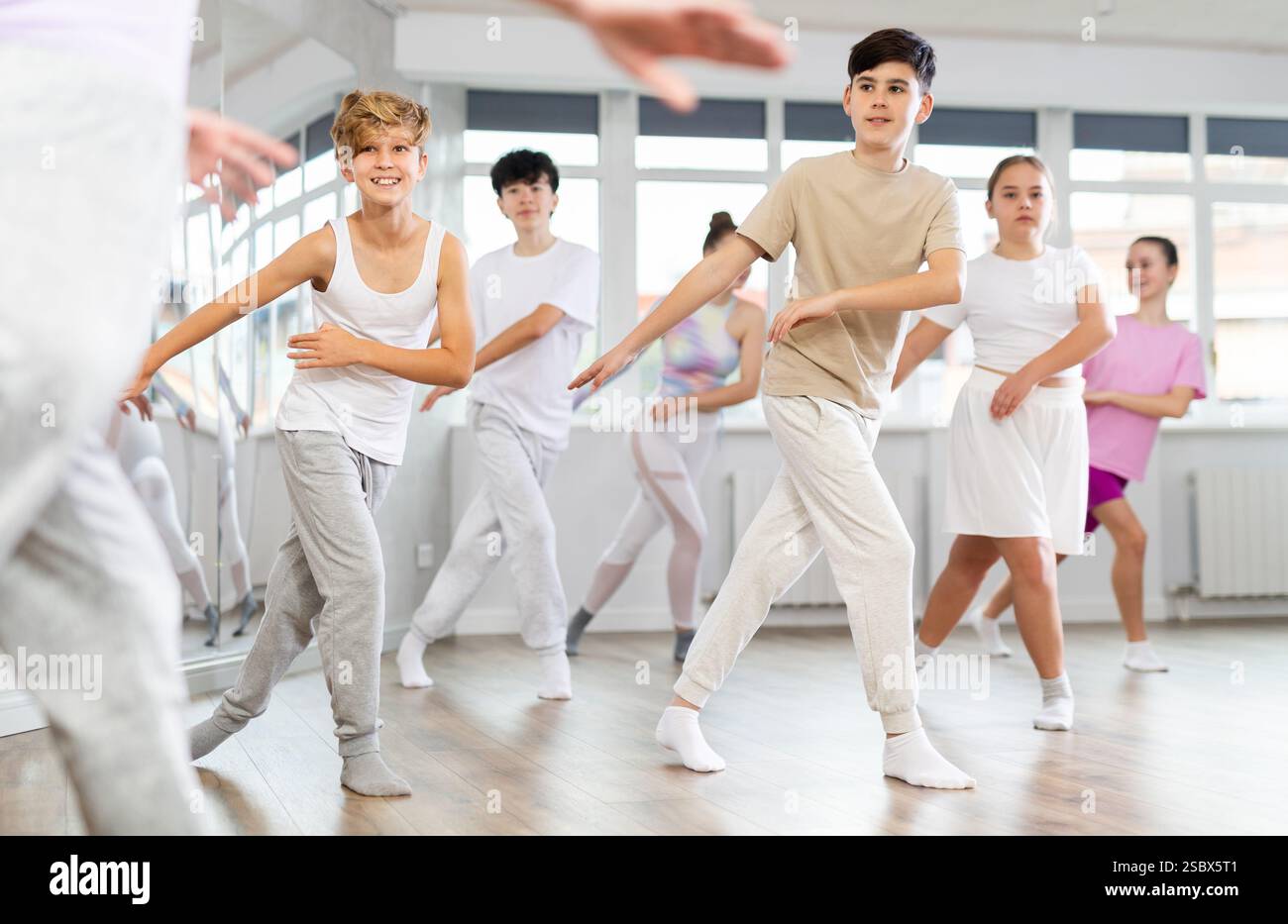 Male boy student repeats movements of unrecognizable teacher during ...