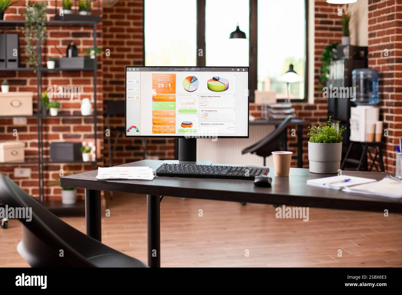 Clean office desk with desktop monitor displaying financial charts is ...