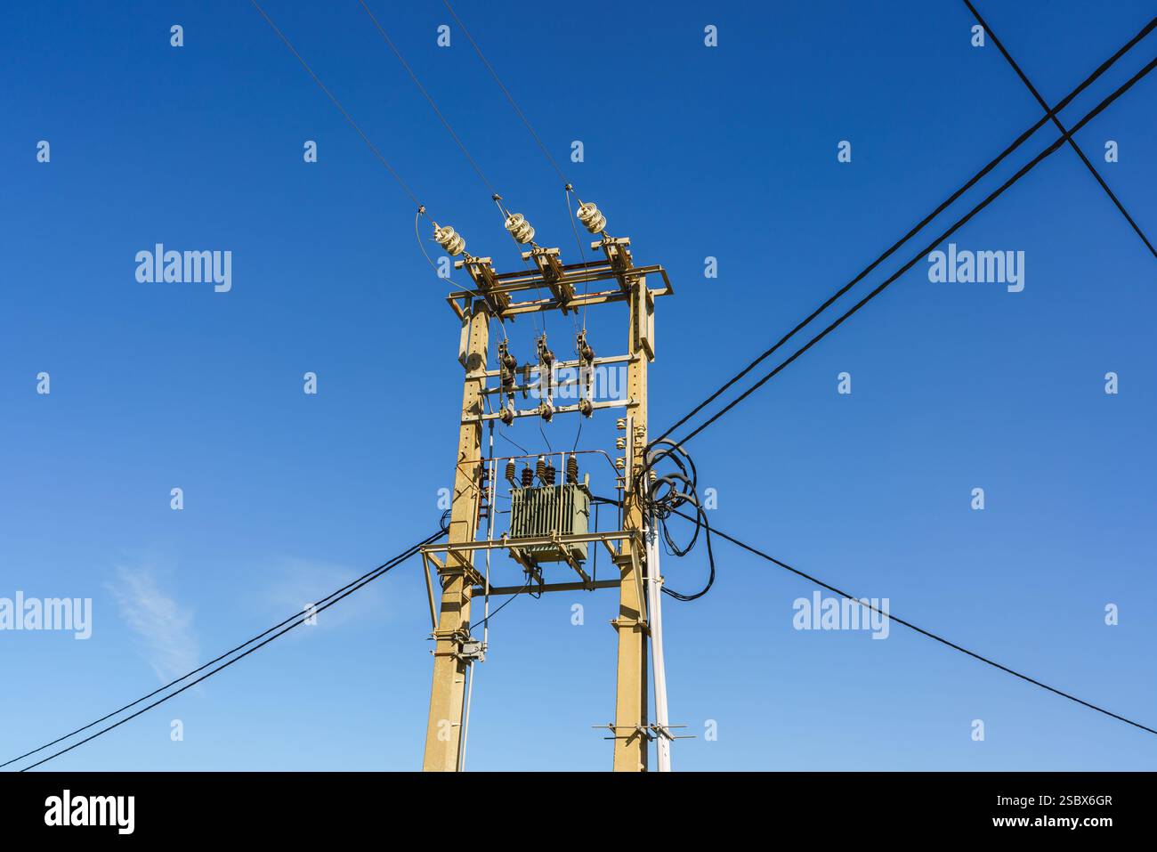 High-voltage power lines and transformer on a utility pole under a ...