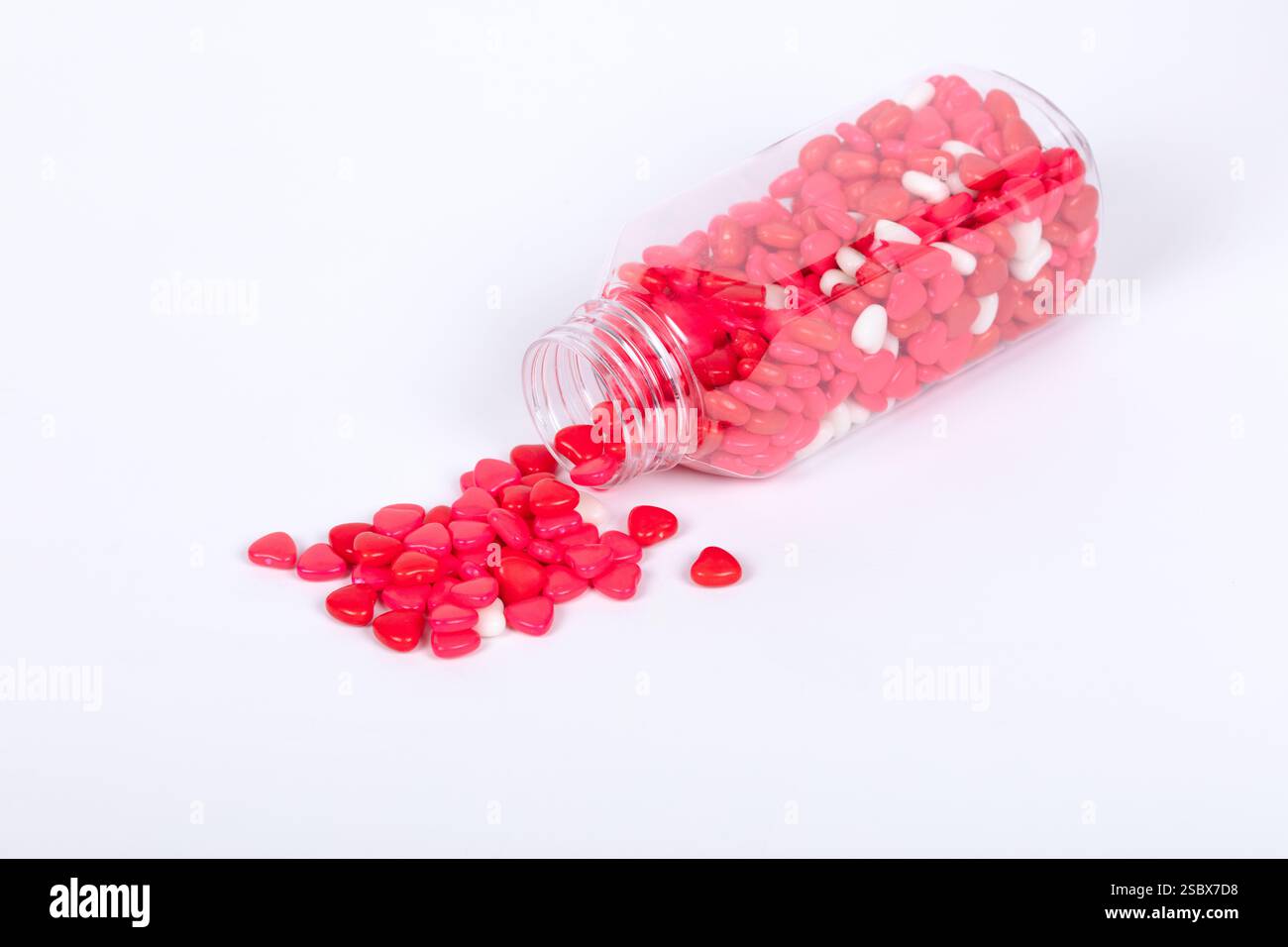 Heart-Shaped Red Pills Spilled from Transparent Plastic Bottle on White ...