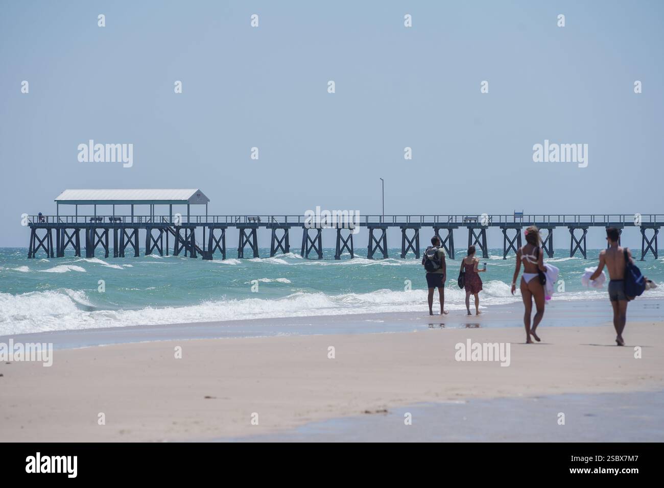 Brighton, Adelaide, Australia 4 February 2025. Beachgoers with jetty ...