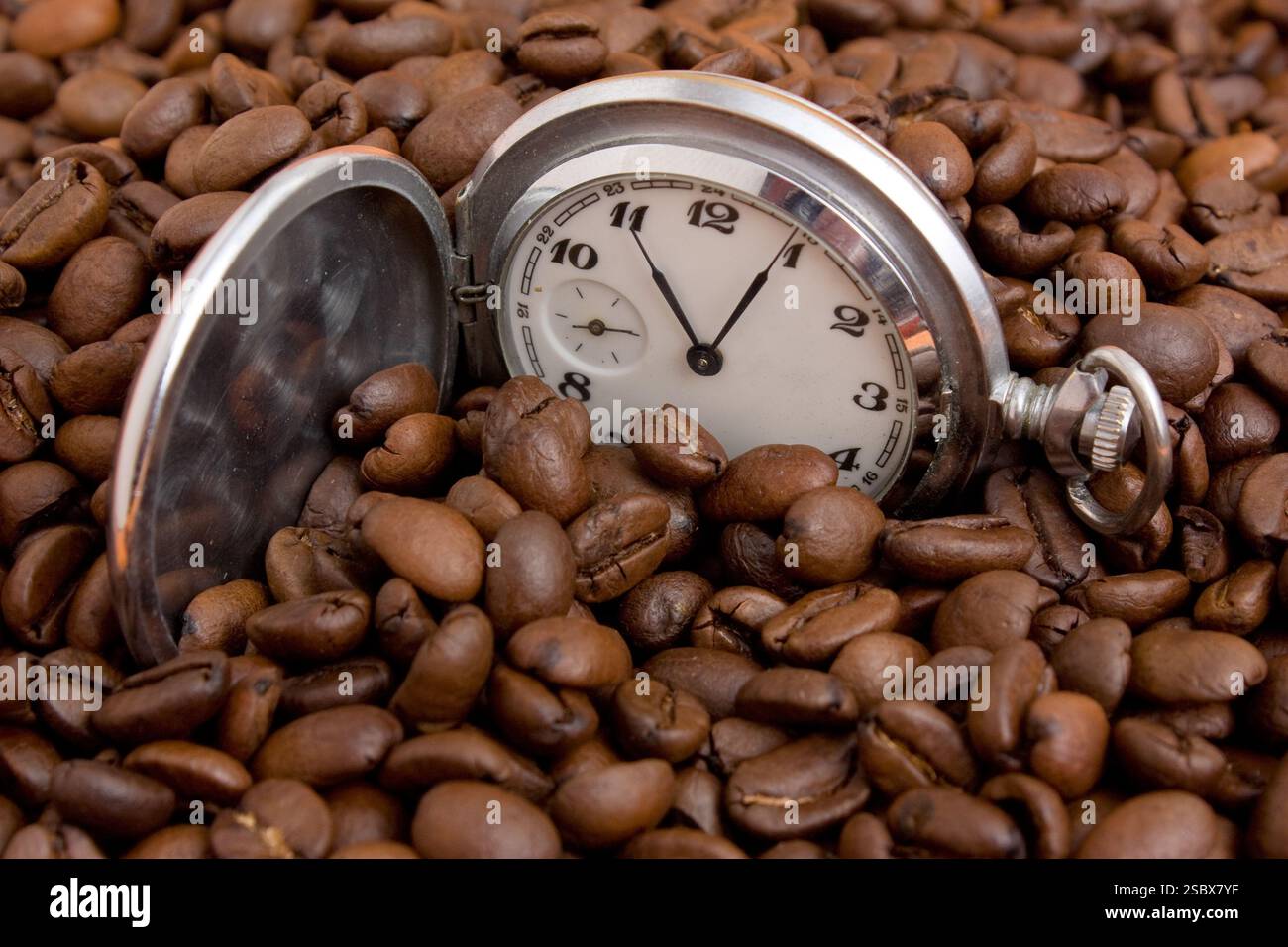 Pocket watch in coffee beans Stock Photo - Alamy