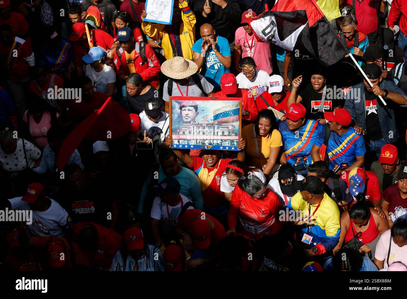 A government supporter holds poster of the late Venezuelan President ...