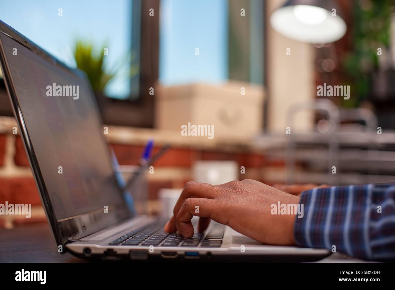 Selective focus of african american person typing on laptop, inputting ...