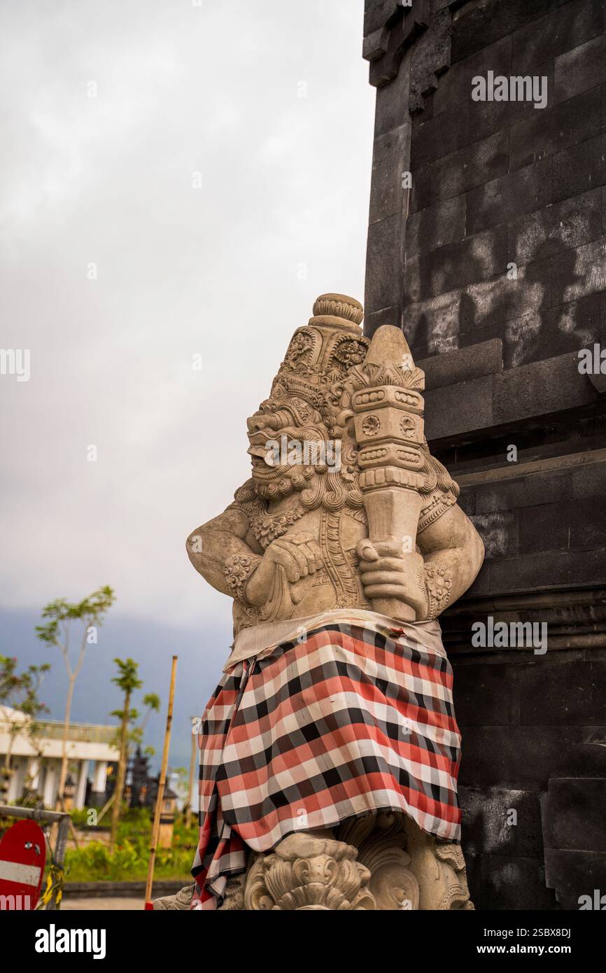 A Barong statue, adorned in a checkered cloth, stands guard outside a ...