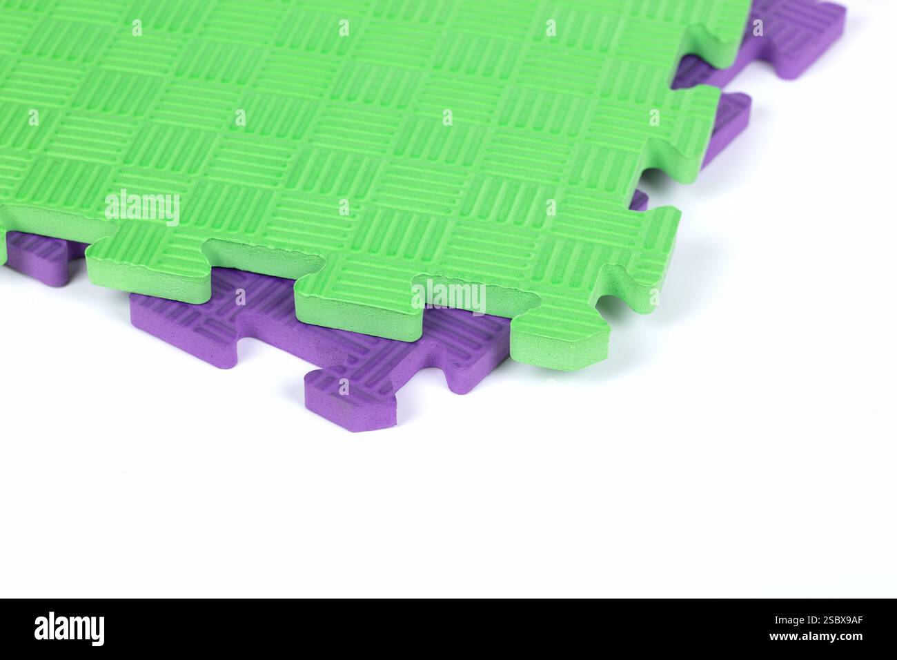 Green and Purple Interlocking Foam Mat Corner: Close-up Detail of ...