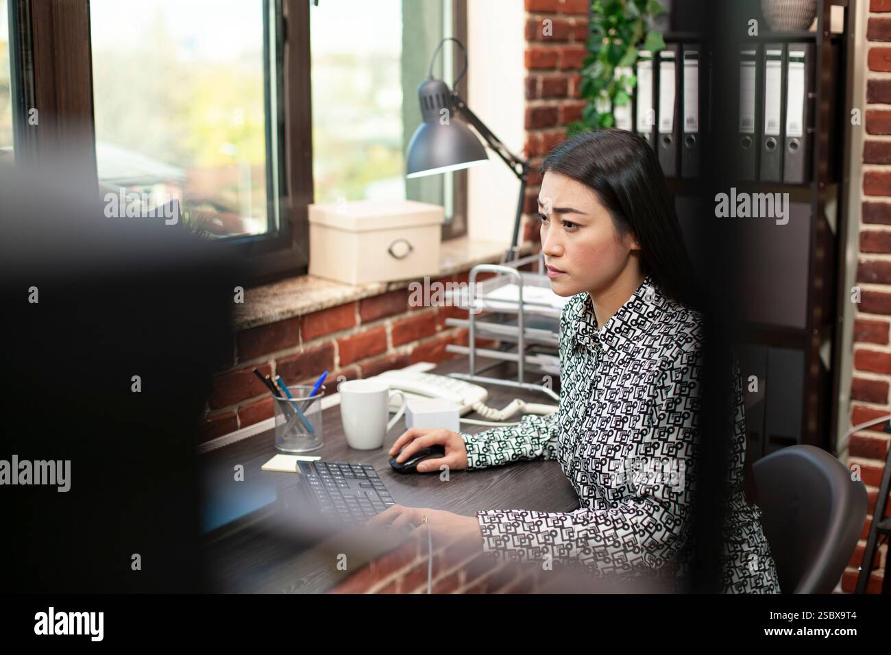 Young woman focused diligently typing hi-res stock photography and ...