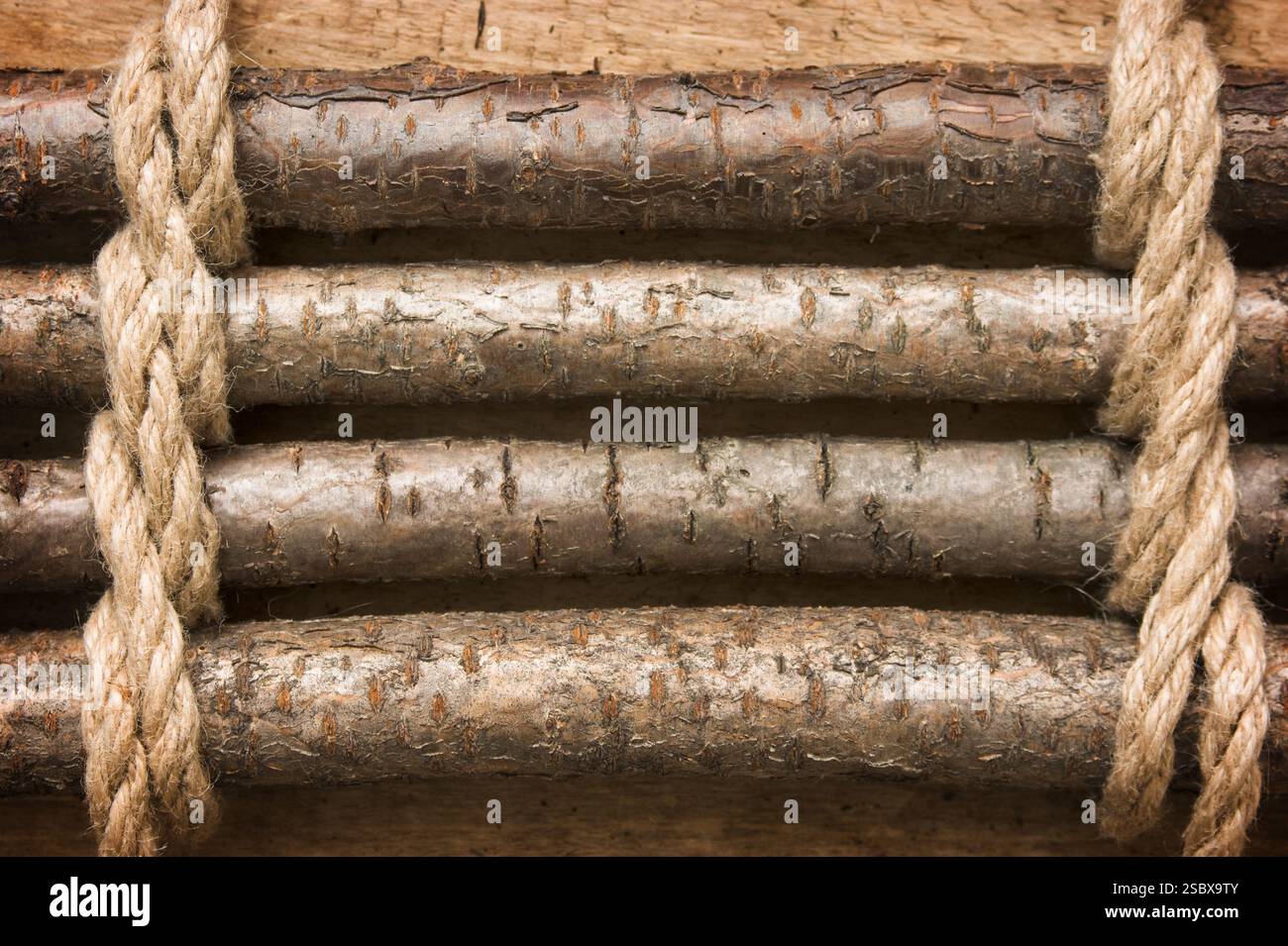 Strips of wood bound with old rope Stock Photo - Alamy