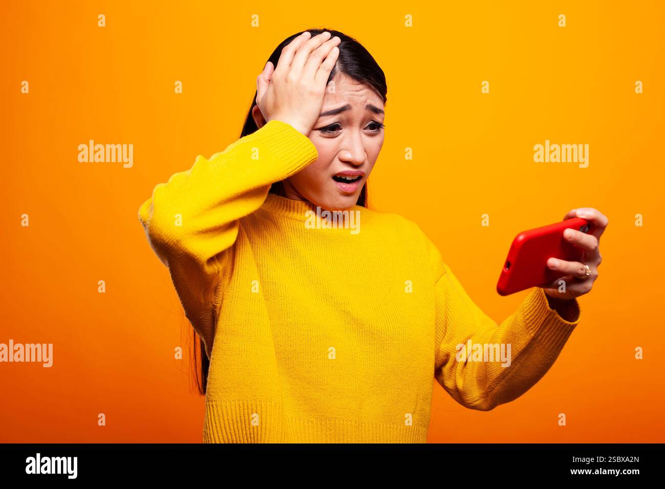 Shocked young woman staring at her smartphone, reacting to bad news ...