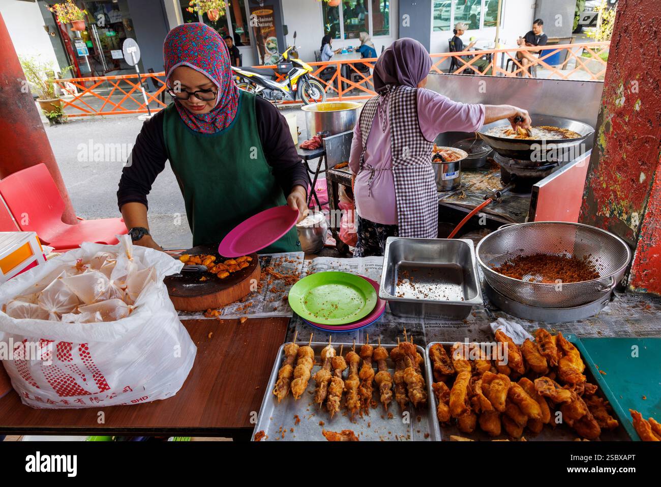 Women serving and cooking street food, Miri, Malaysia Stock Photo - Alamy