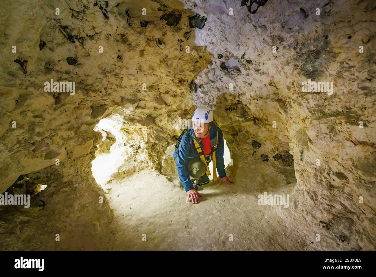 Visitor crawling through the Neolithic flint mines of Spiennes, Mons ...