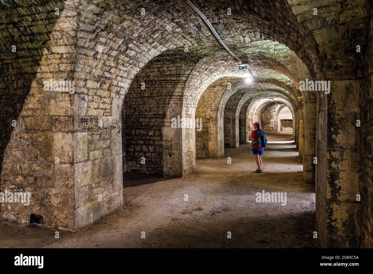 Person standing in the underground tunnel fortifications in the ...