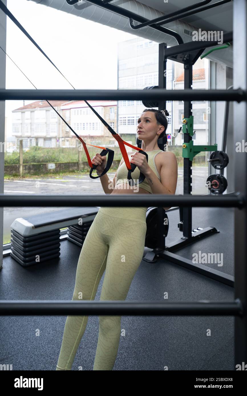 Woman exercises suspension straps hi-res stock photography and images ...