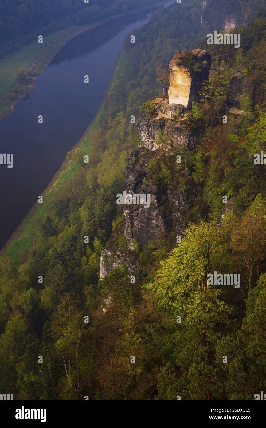 The bright lit Wartturm above the Elbe river seen from the Bastei rocks ...