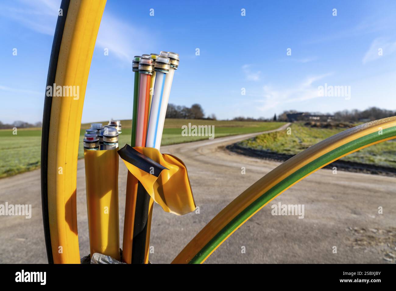 Fibre optic connection, empty conduits protrude from the ground along a ...