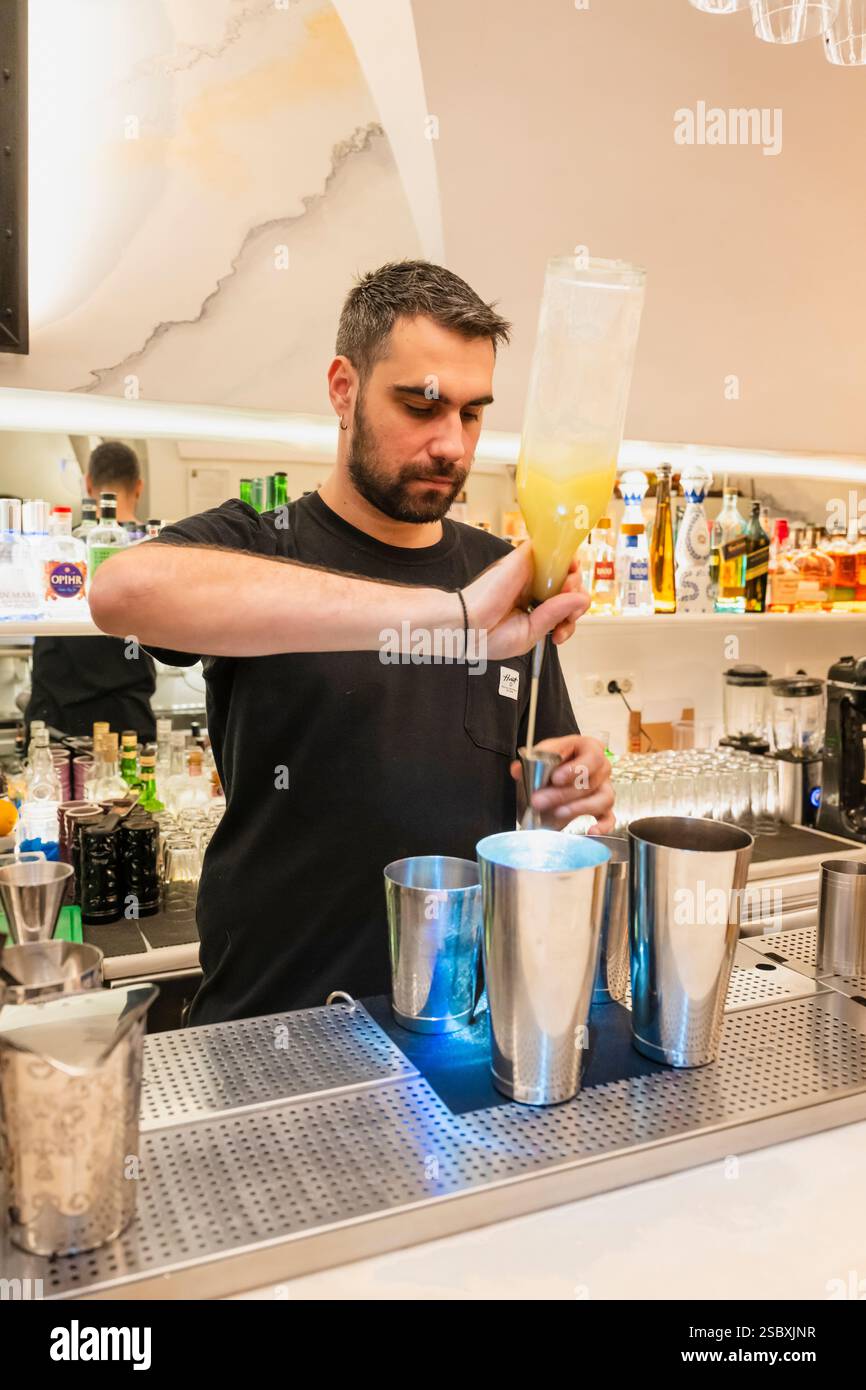 A Greek barkeeper mixes a drink at the counter of the Hassapiko Bar in ...