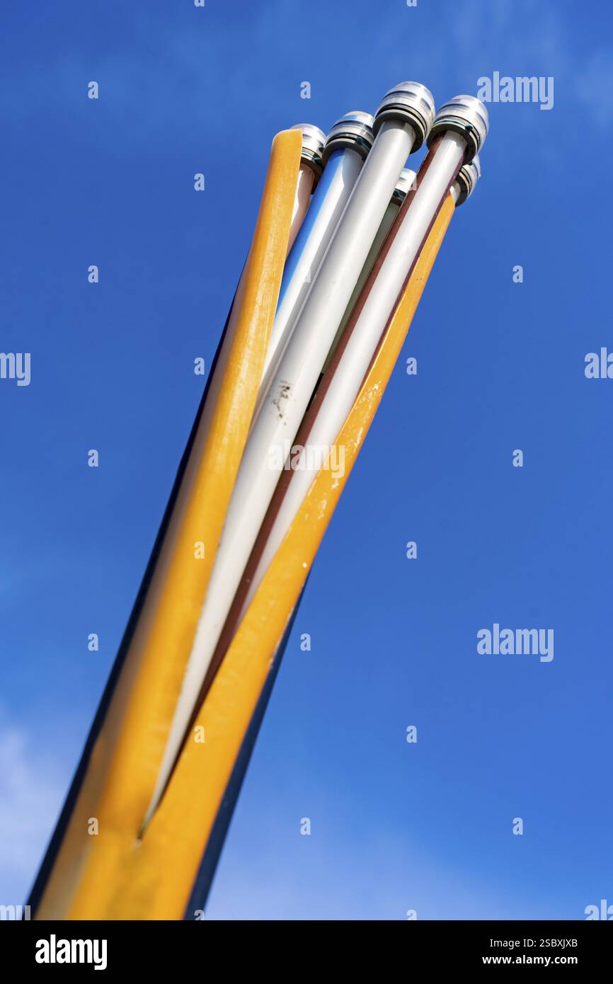 Fibre optic connection, empty conduits protrude from the ground along a ...