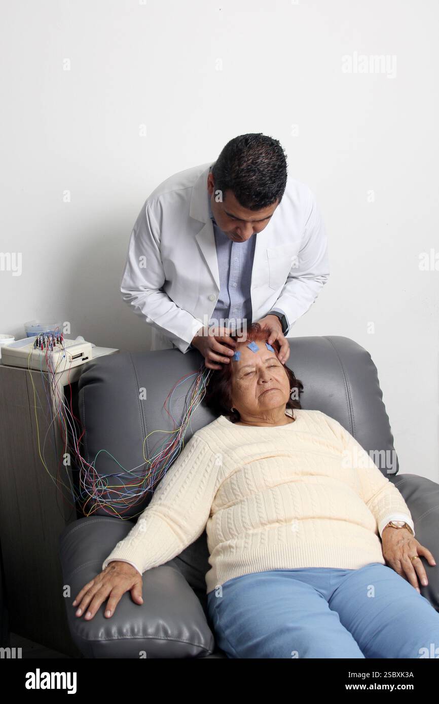 Elderly Latin woman undergoes EEG electroencephalogram to detect dementia or Alzheimer's disease ...