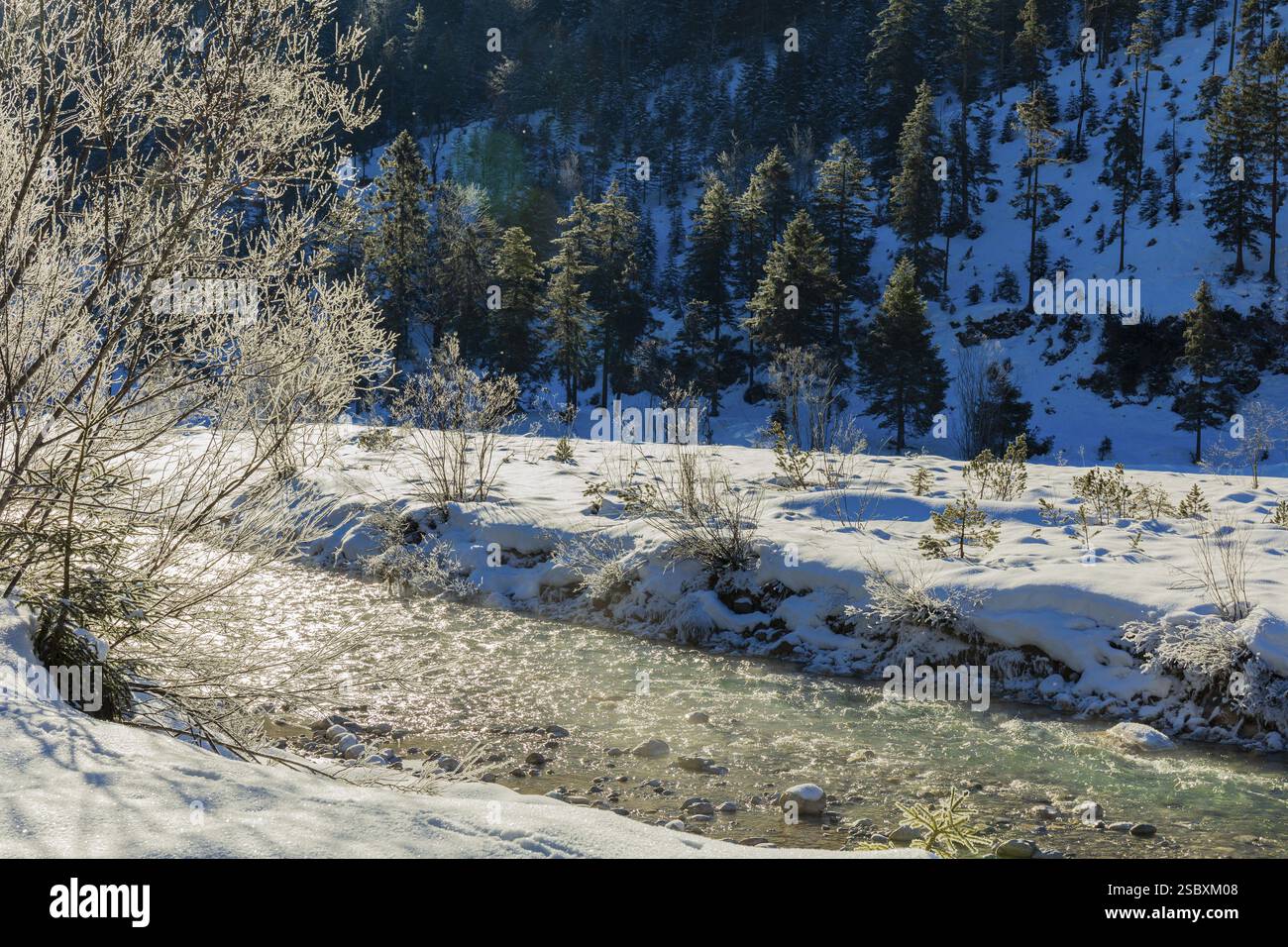 The Riss creek flowing through a snow covered landscape in the Eng ...