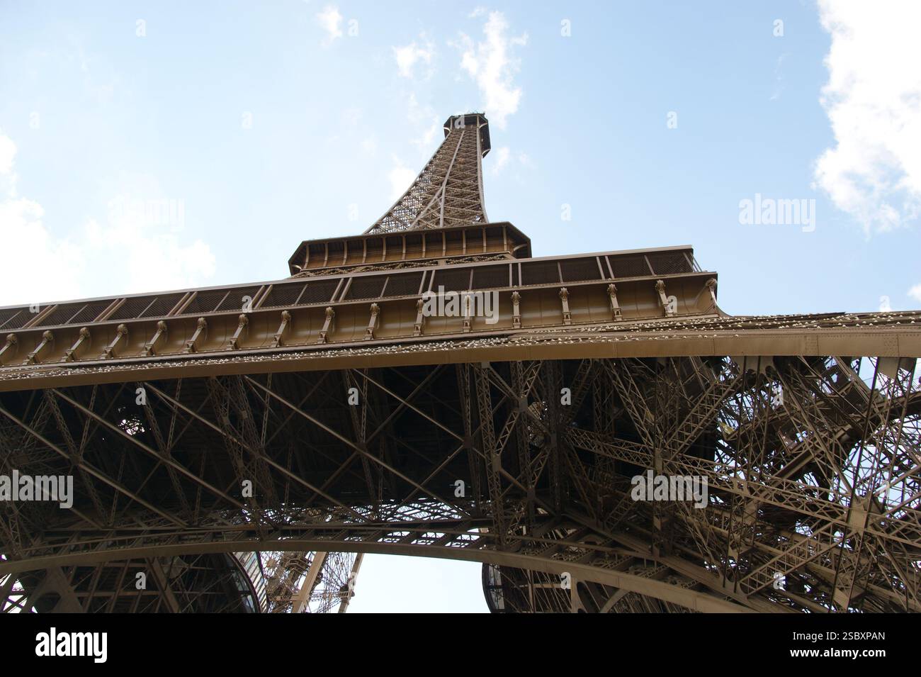 A close-up photo of the Eiffel Tower taken from below on a partially ...
