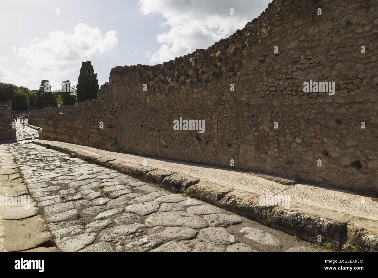 Long narrow stone sidewalk and street made of large grey smooth and ...