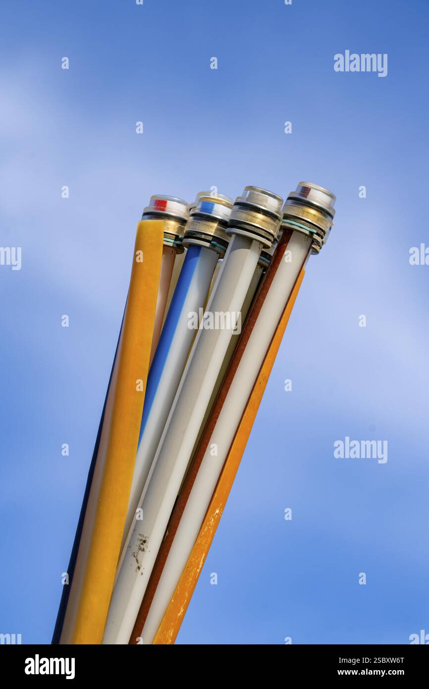 Fibre optic connection, empty conduits protrude from the ground along a ...