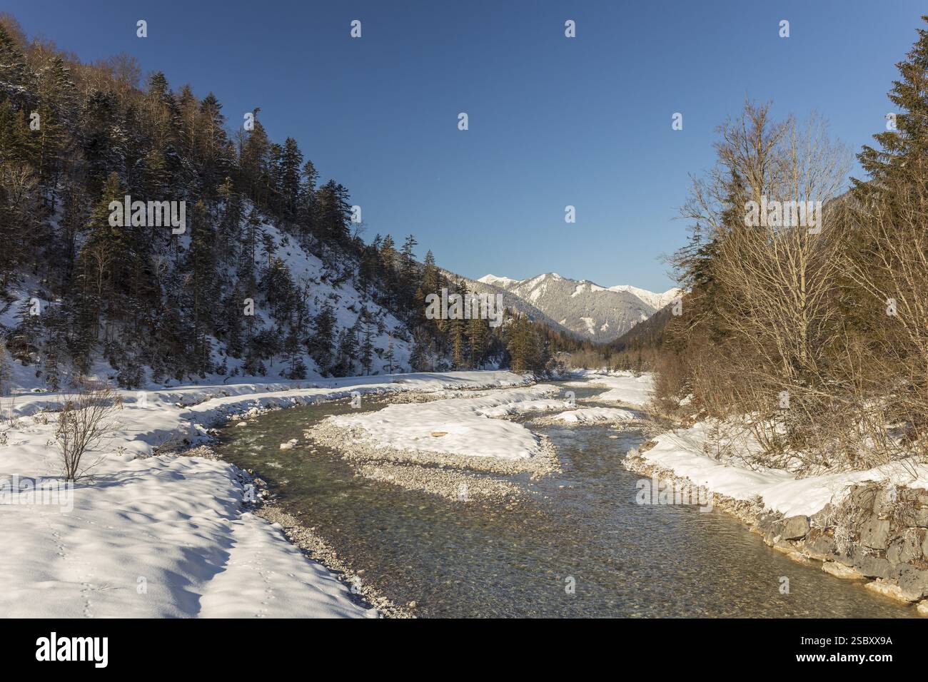 The Riss creek flowing through a snow covered landscape in the Eng ...