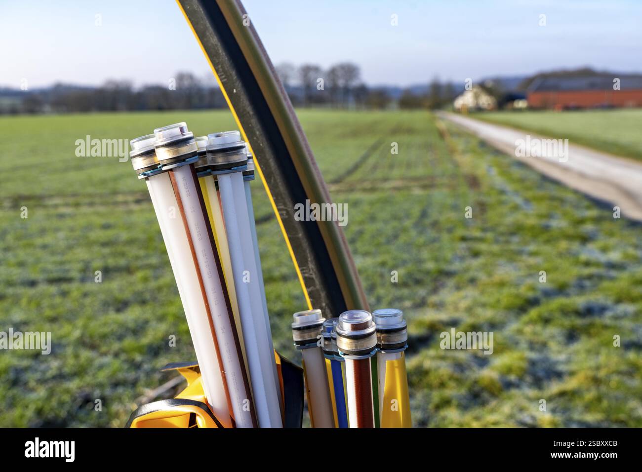 Fibre optic connection, empty conduits protrude from the ground along a ...
