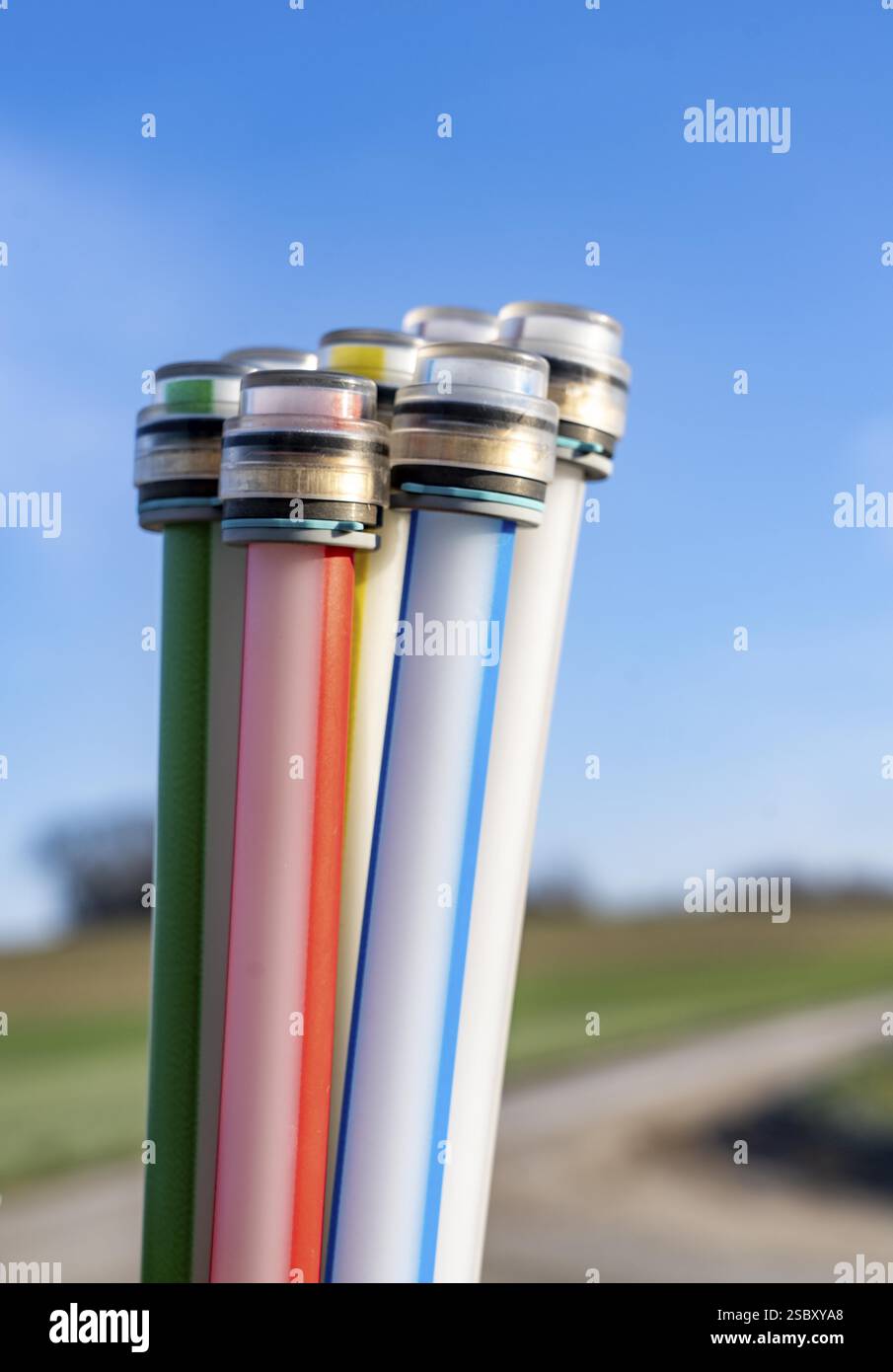 Fibre optic connection, empty conduits protrude from the ground along a ...