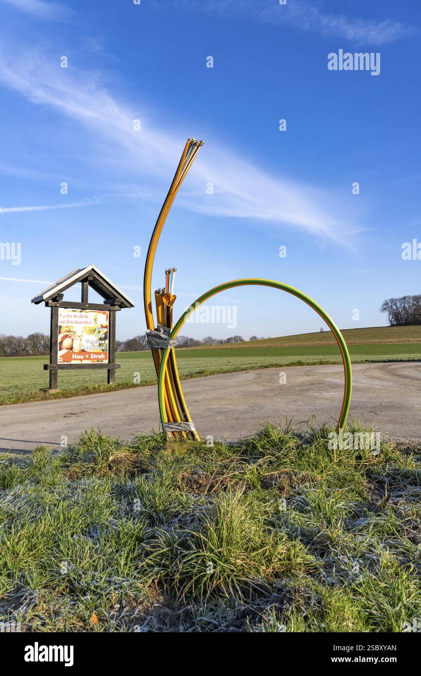 Fibre optic connection, empty conduits protrude from the ground along a ...