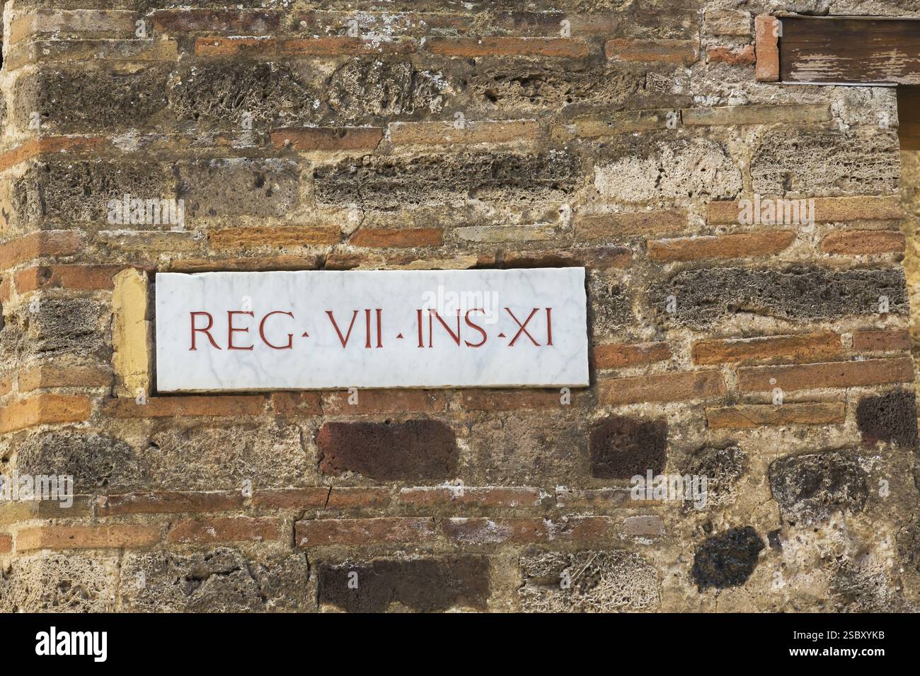 Street names inscribed on white marble plaques on terracotta brick and ...