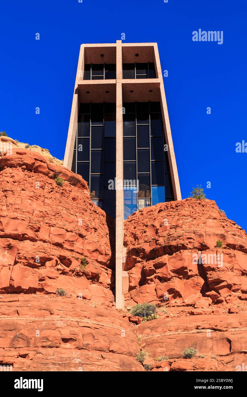 A tall building with a cross on top of it. The building is made of ...