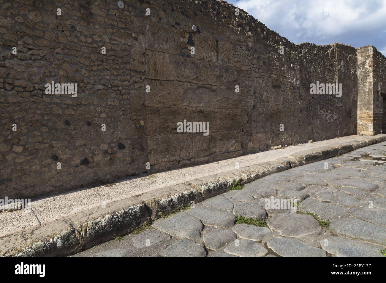 Long narrow stone sidewalk and street made of large grey smooth and ...