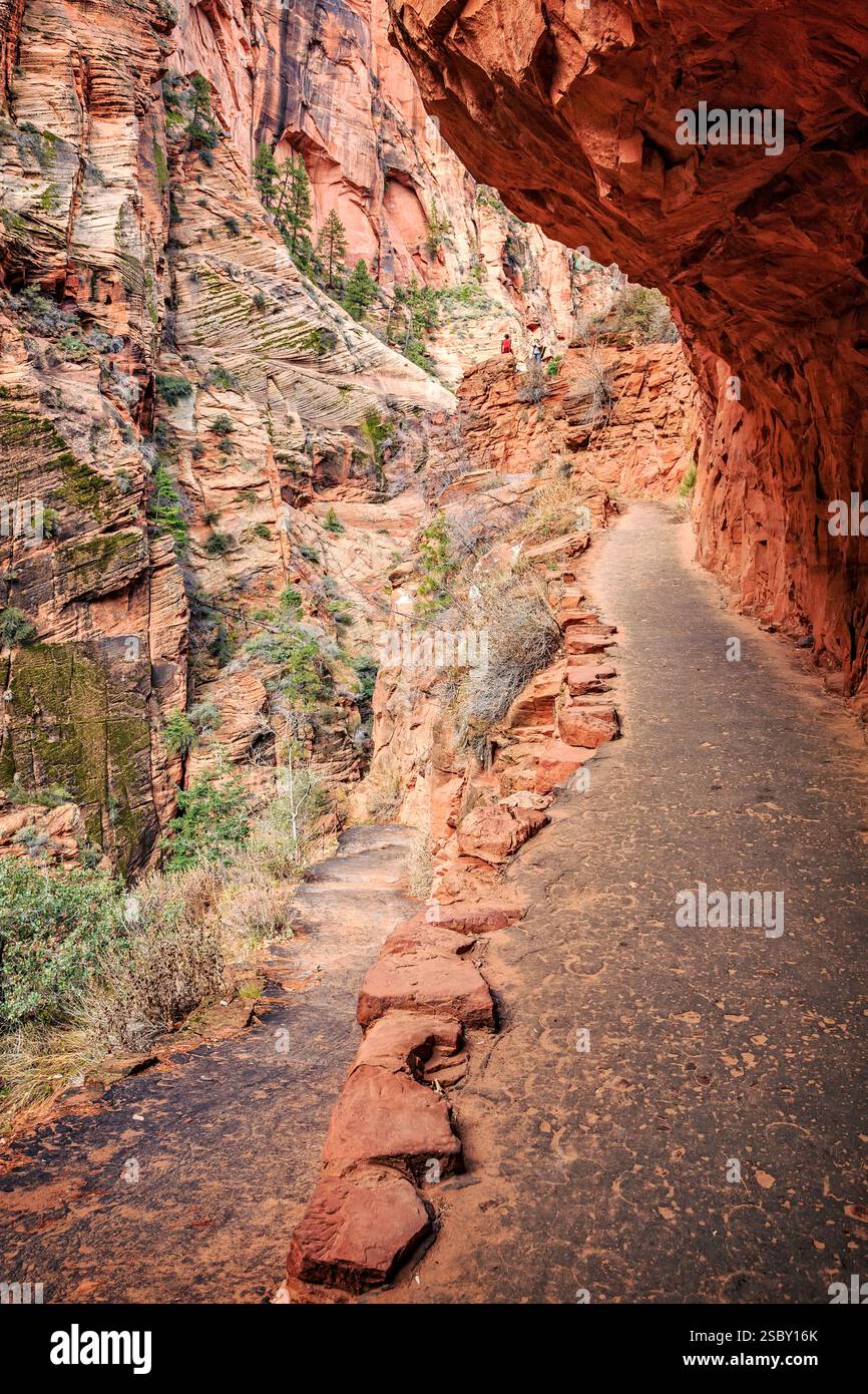 Path is shown in a canyon with a rock wall on the side. The path is ...