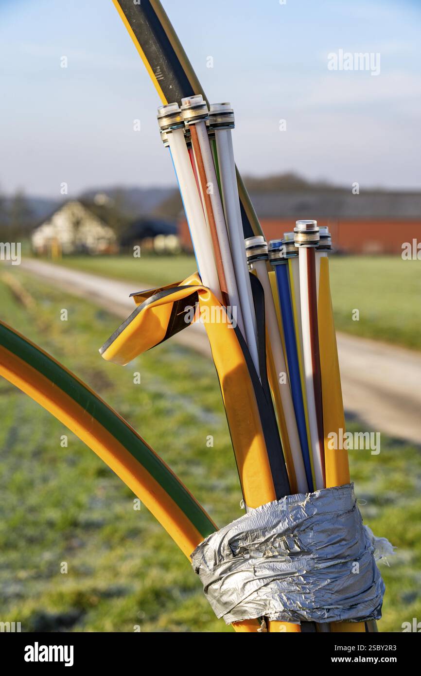 Fibre optic connection, empty conduits protrude from the ground along a ...