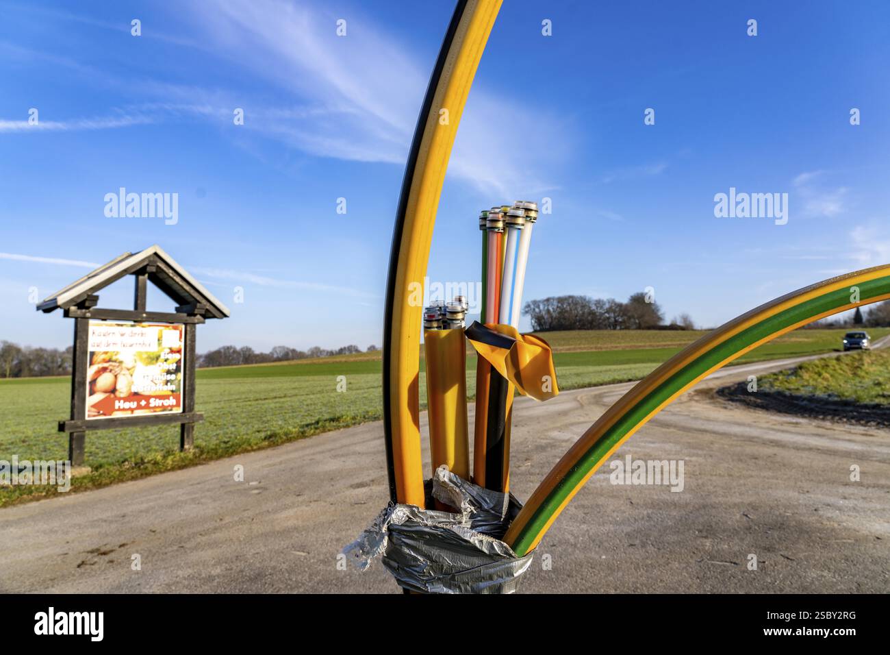 Fibre optic connection, empty conduits protrude from the ground along a ...