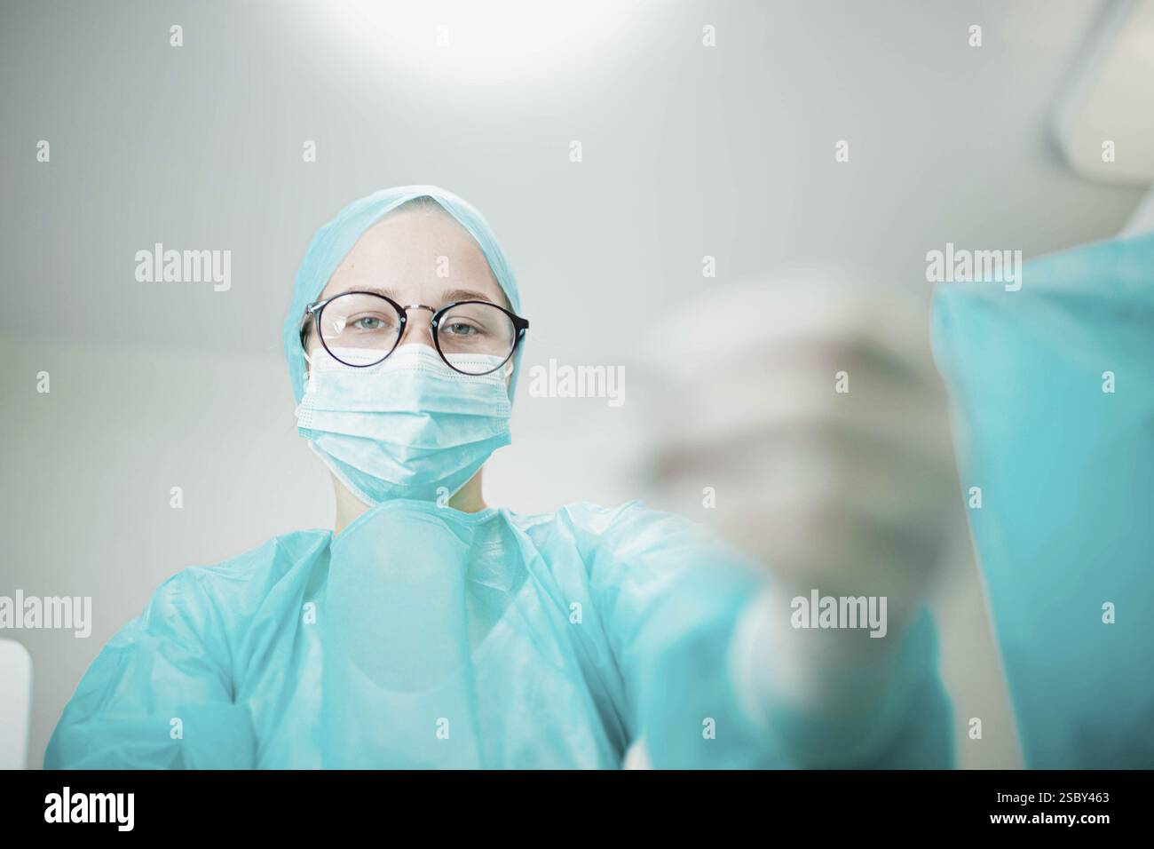 Surgeon making a gesture with a blurred hand Stock Photo - Alamy