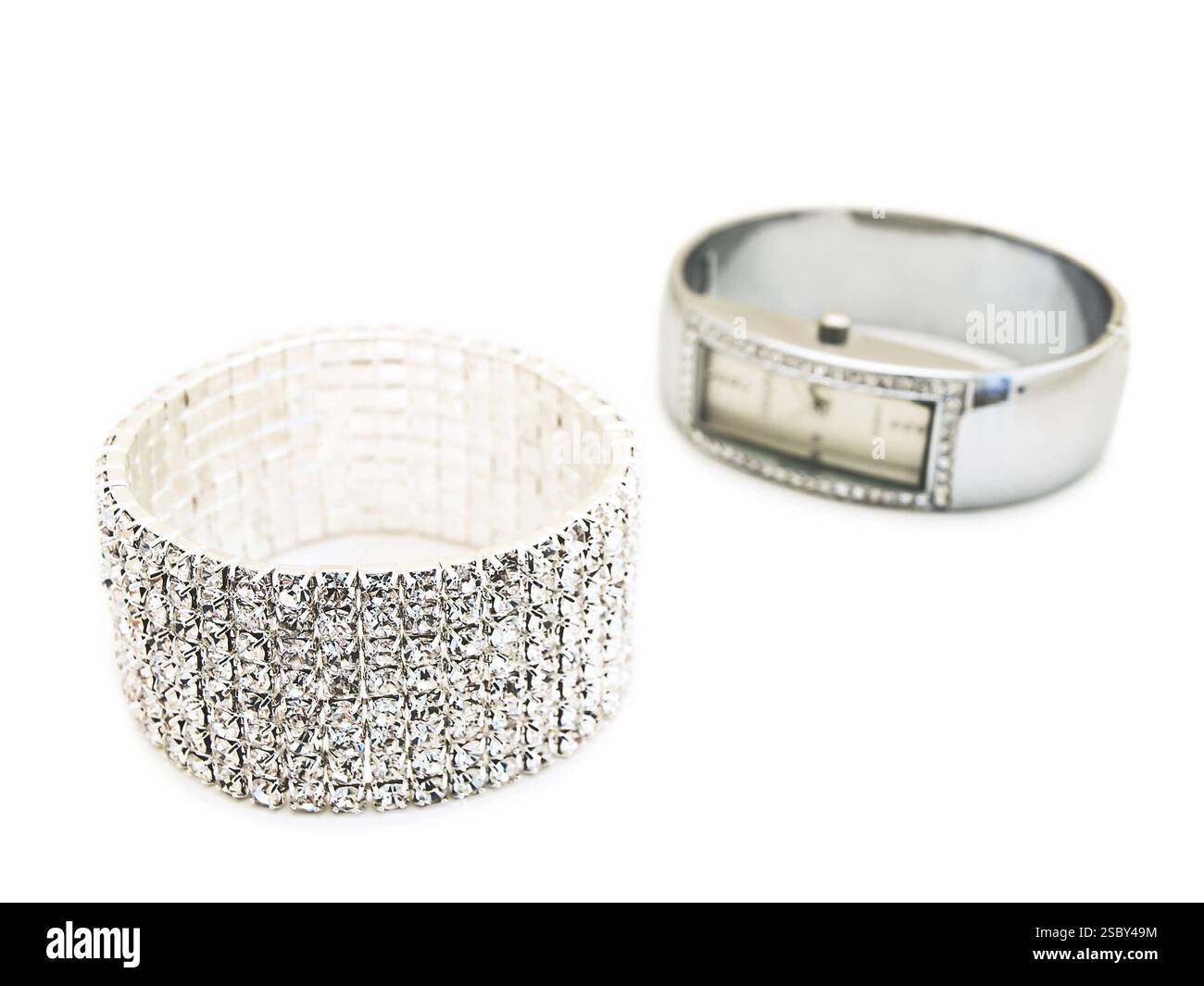 Jewellery and clock against the white background Stock Photo - Alamy